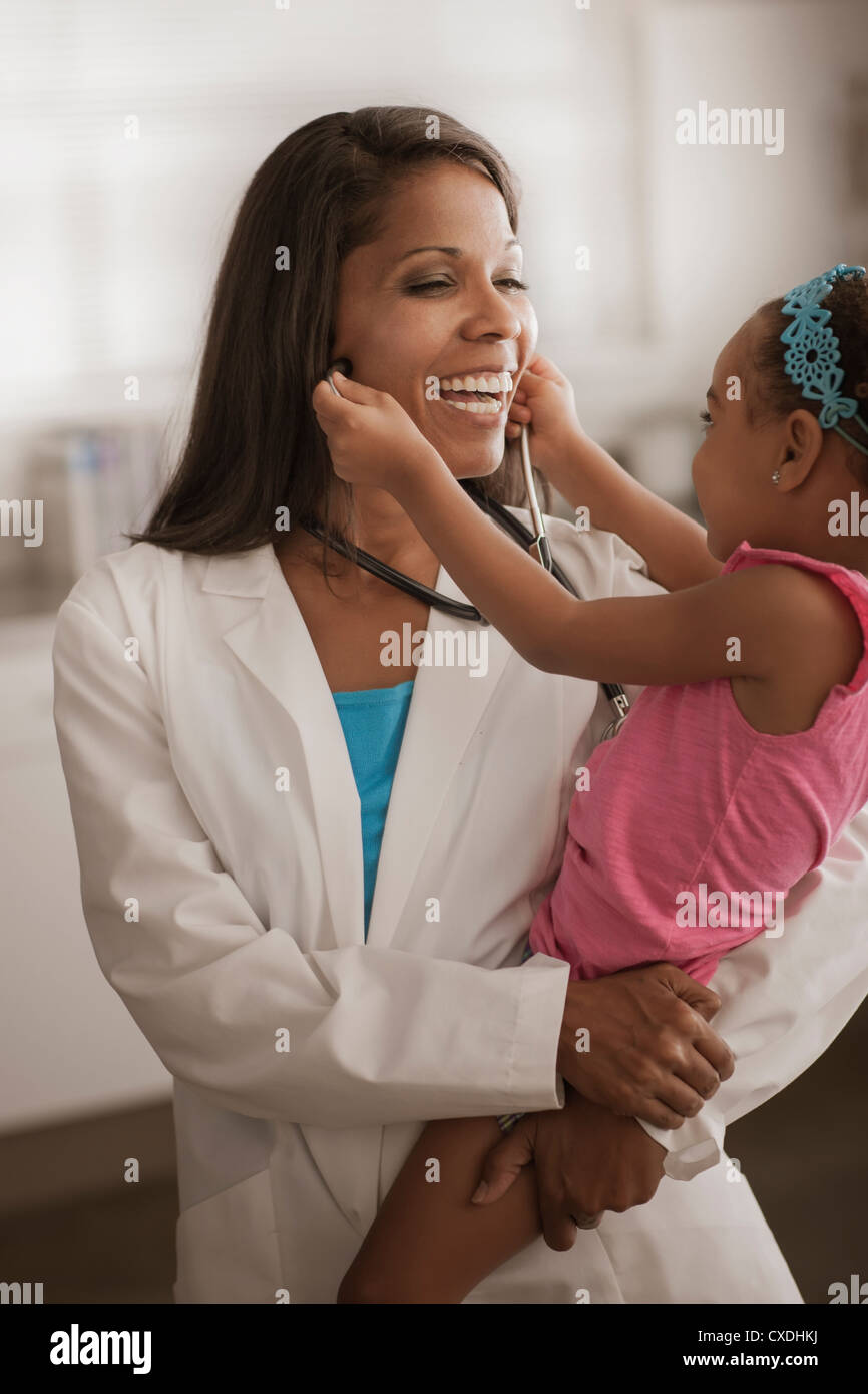 Mixed race doctor holding patient Stock Photo - Alamy