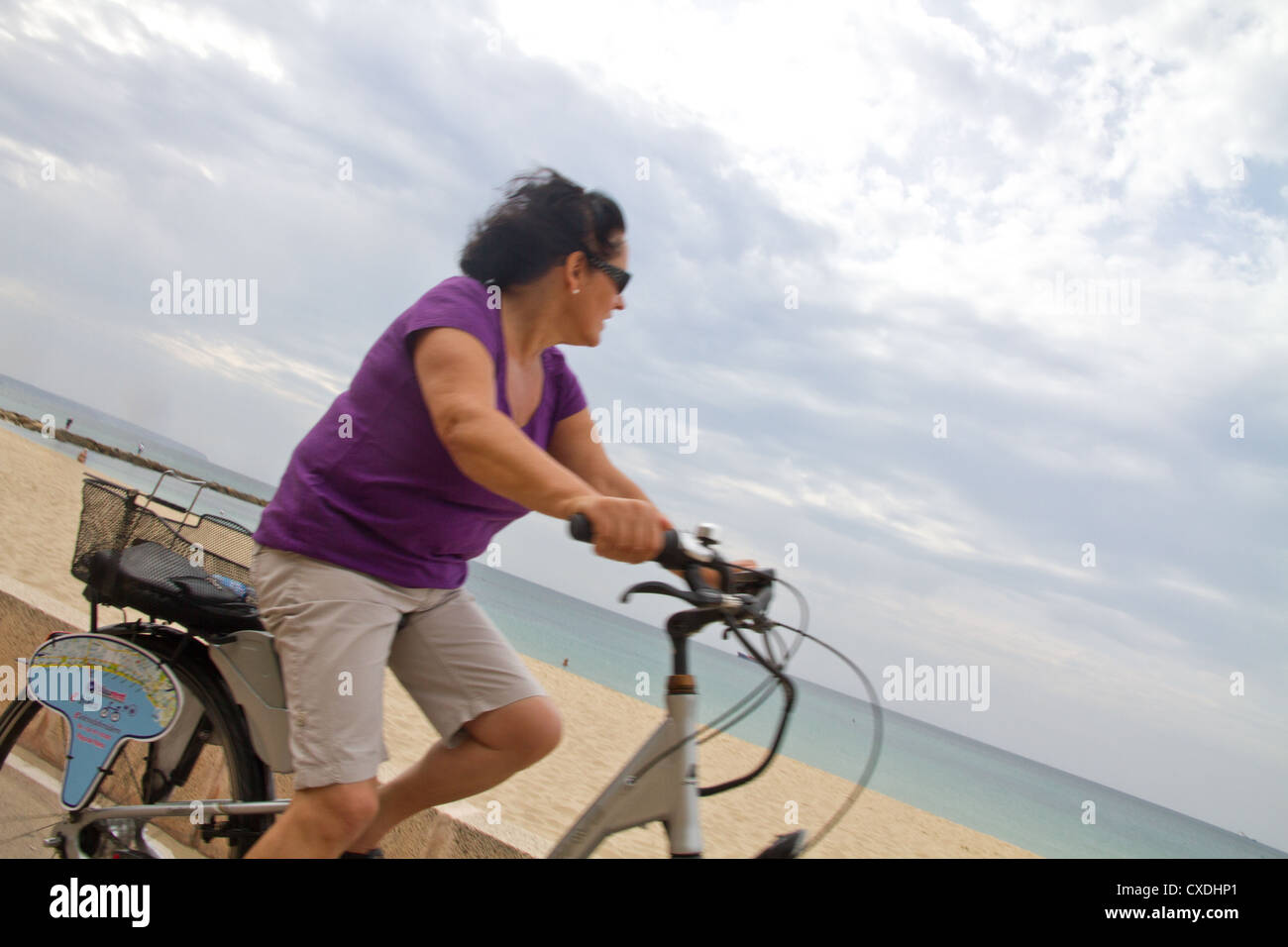 Woman Riding bike on path, person cycling on bicycle path on promenade ...