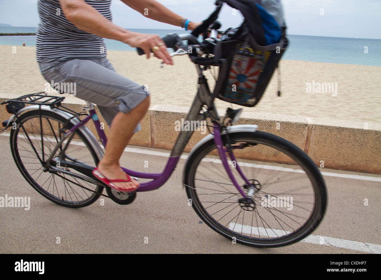 Woman Riding bike on path, person cycling on bicycle path on promenade ...
