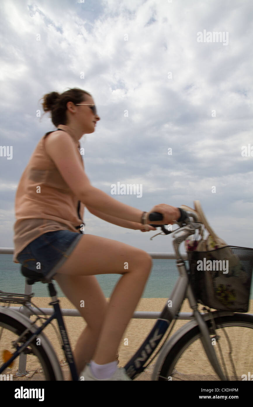 Woman Riding bike on path, person cycling on bicycle path on promenade ...
