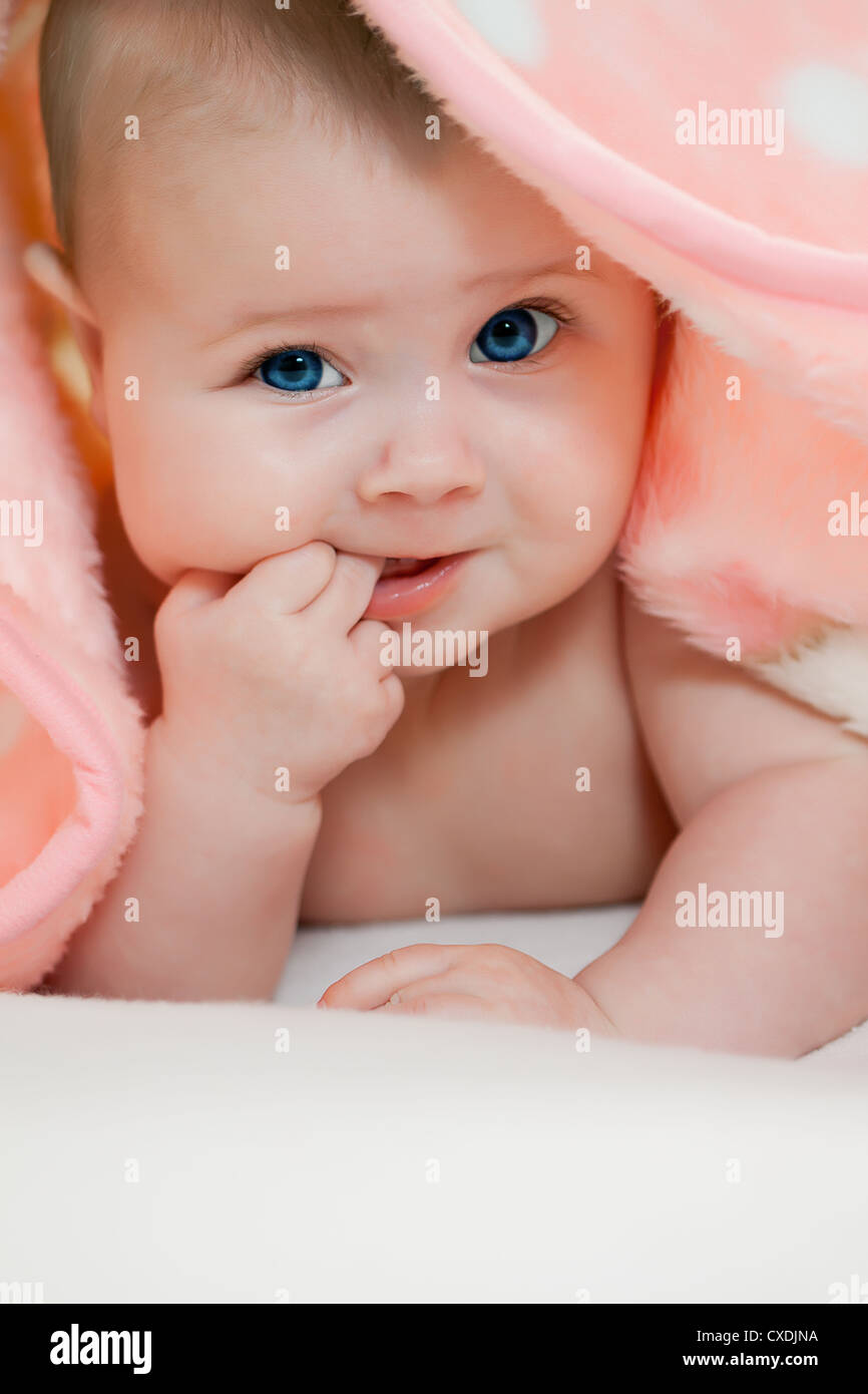 Charming baby. Beautiful baby under pink towel Stock Photo - Alamy
