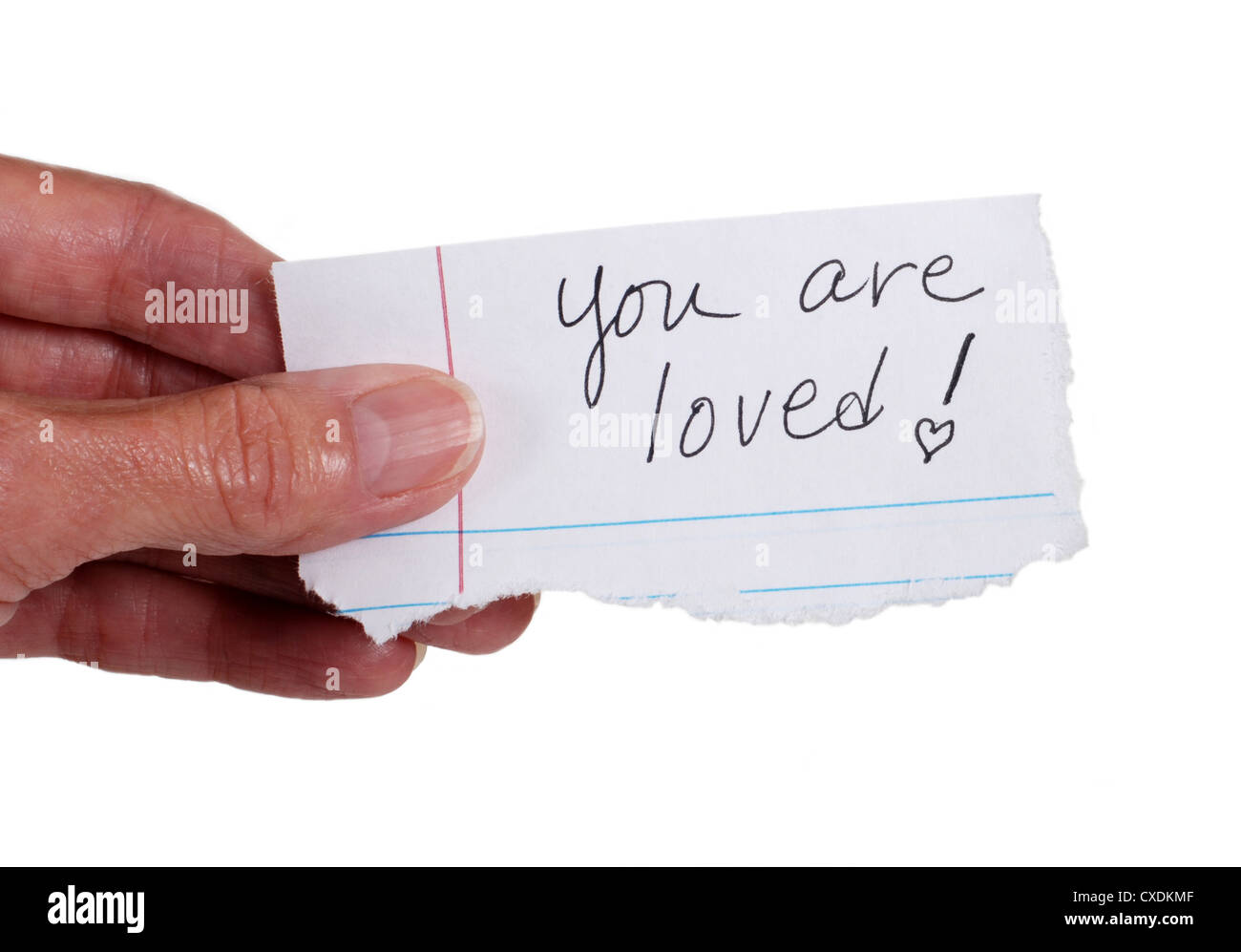 Close up of a hand holding a note with the words: 'You Are Loved ...