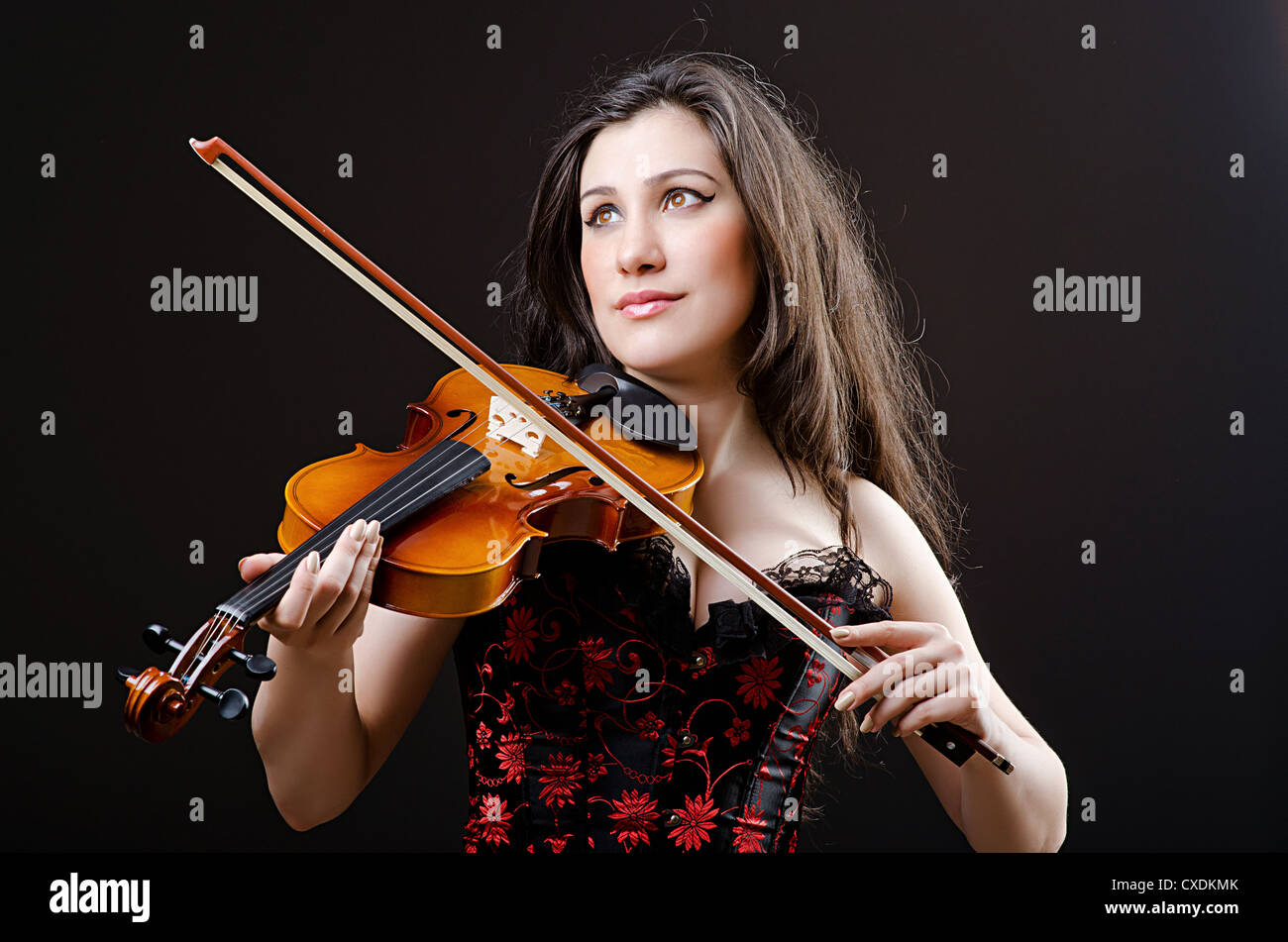 Female violin player against background Stock Photo - Alamy