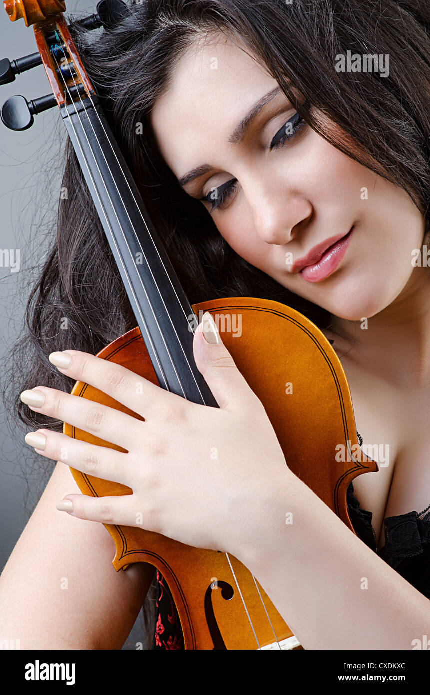 Female violin player against background Stock Photo - Alamy
