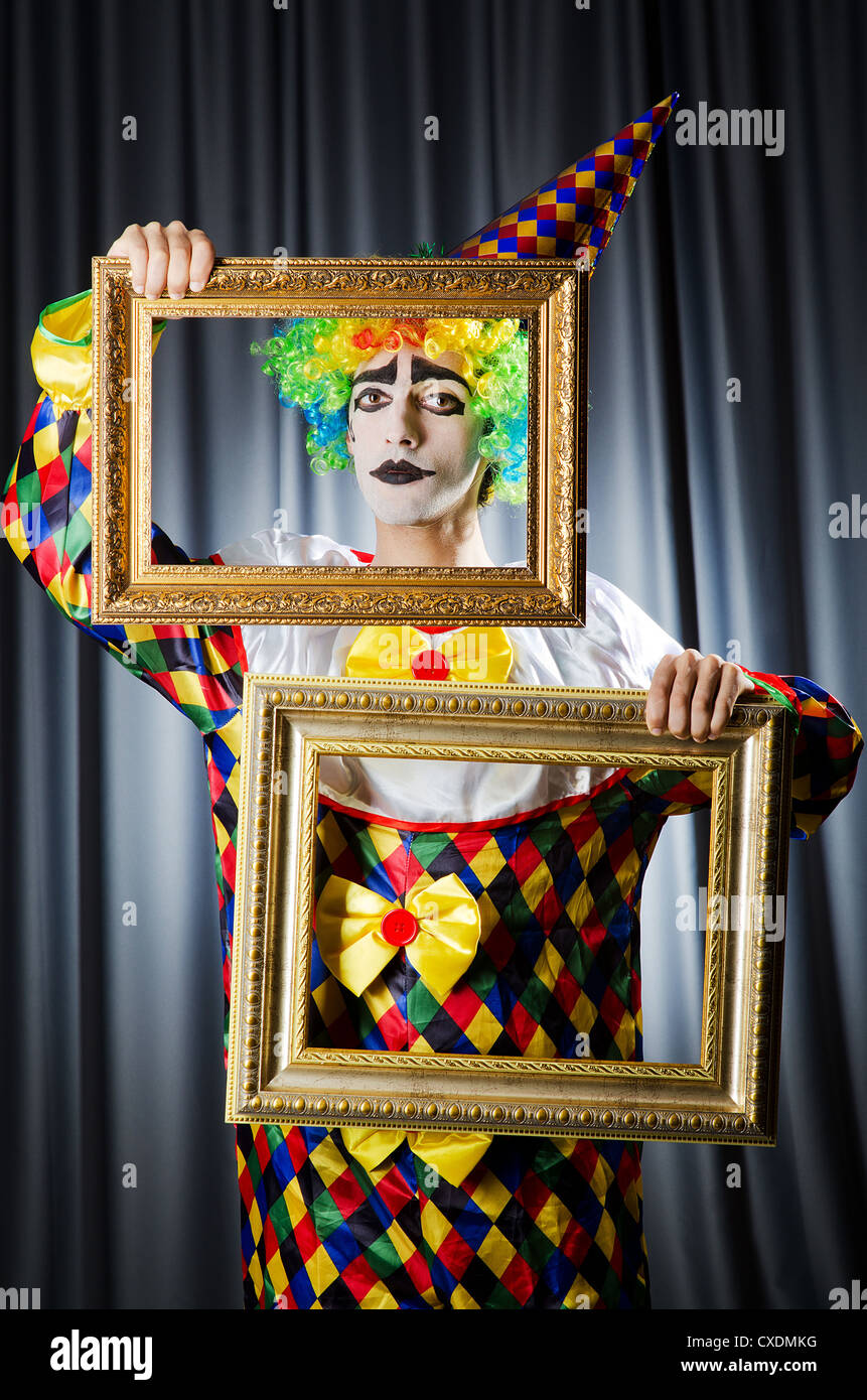 Clown with picture frames in studio Stock Photo - Alamy