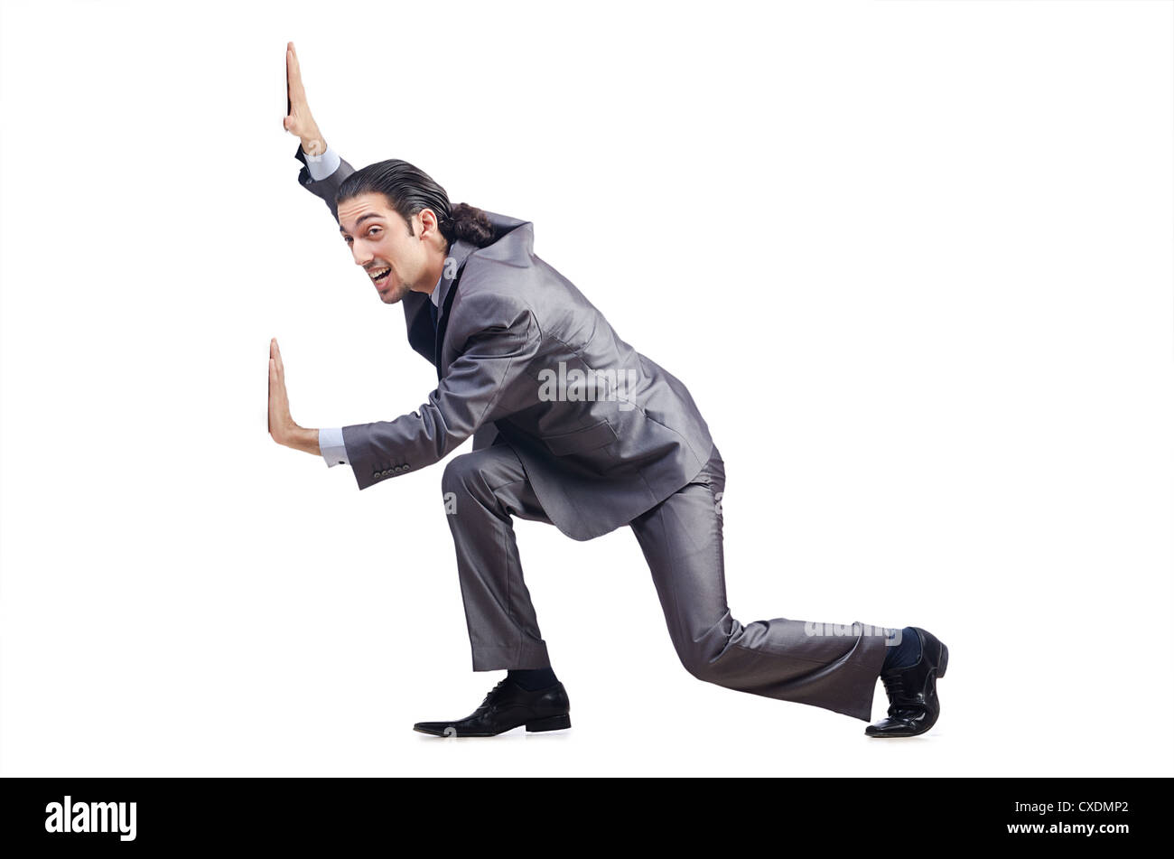 Young businessman pushing invisible obstacles Stock Photo - Alamy