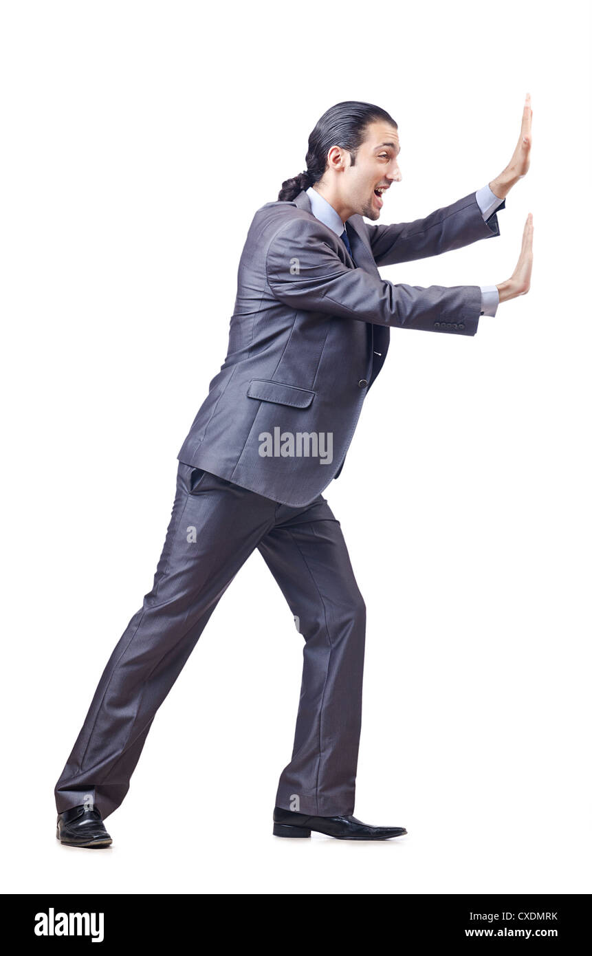Young businessman pushing invisible obstacles Stock Photo - Alamy