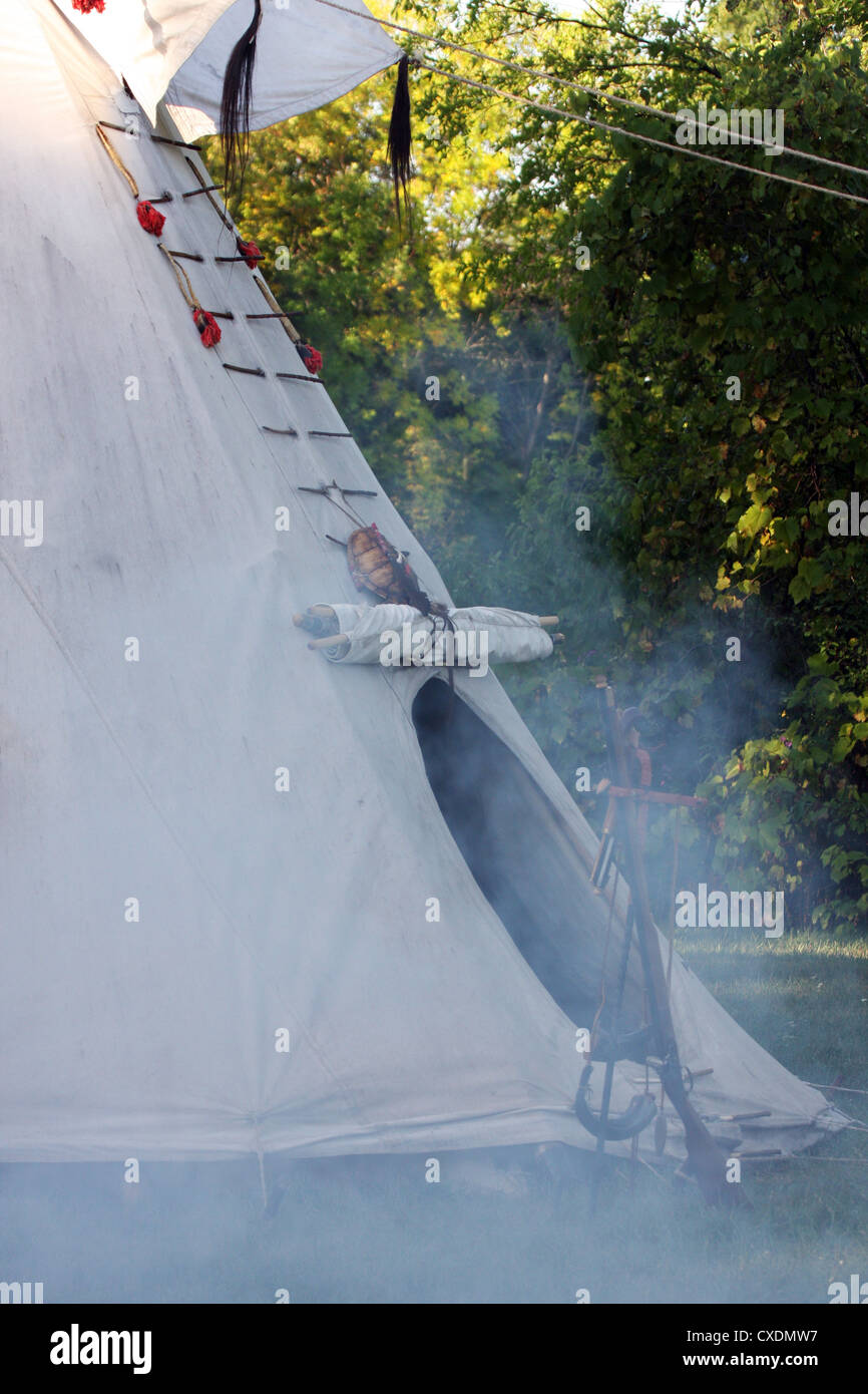 Native American Indian tipi with smoke from a campfire Stock Photo - Alamy
