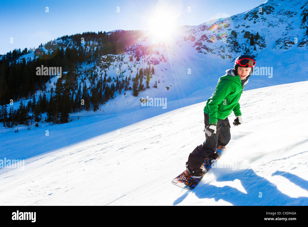 Mixed race teenager snowboarding Stock Photo - Alamy