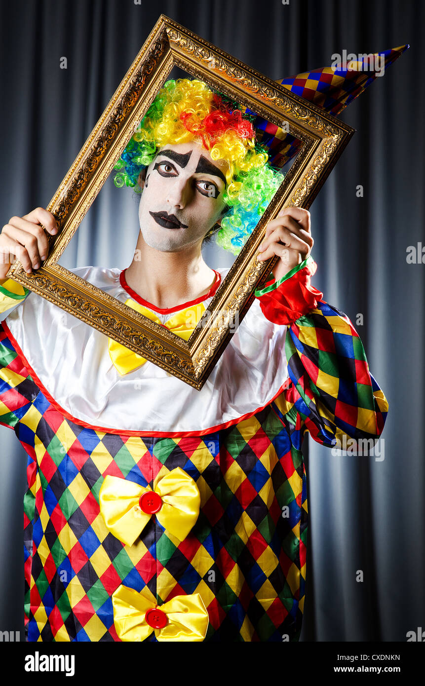 Clown with picture frames in studio Stock Photo - Alamy