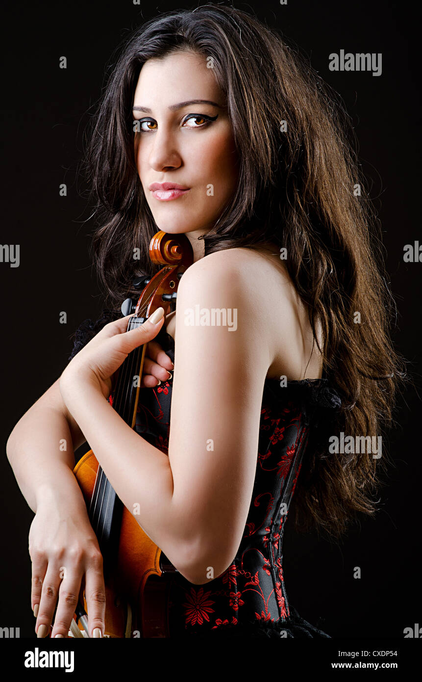 Female violin player against background Stock Photo - Alamy