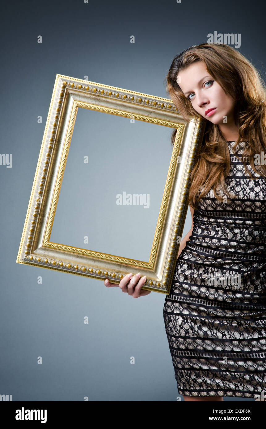 Young woman with picture frame on white Stock Photo - Alamy