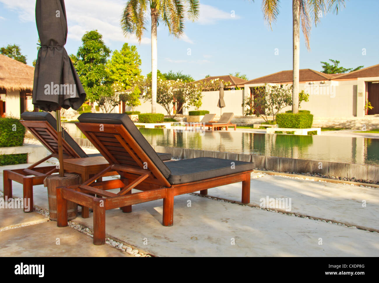 Seats beside the swimming pool Stock Photo - Alamy