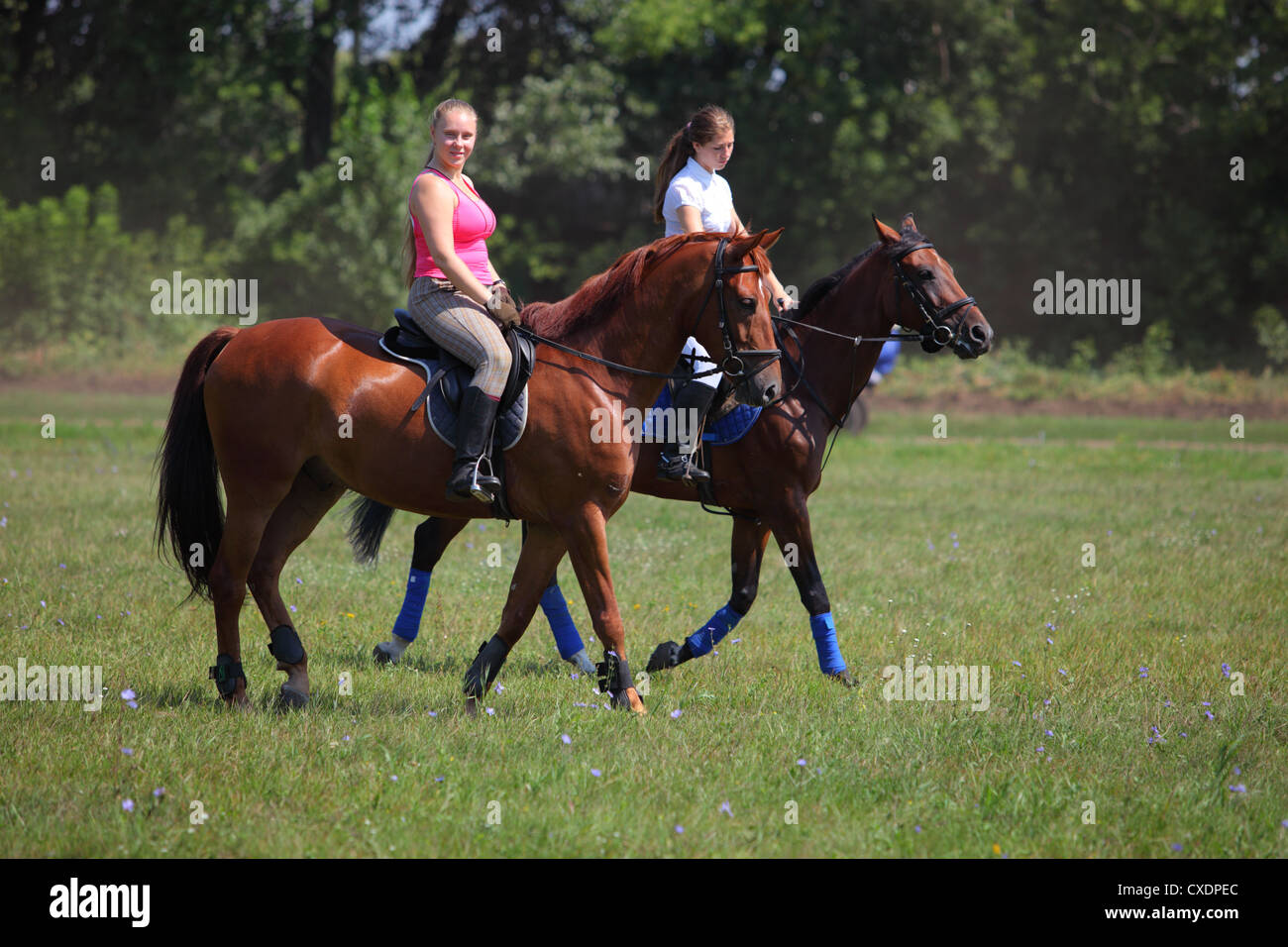 Two girls riding horse hi-res stock photography and images - Alamy