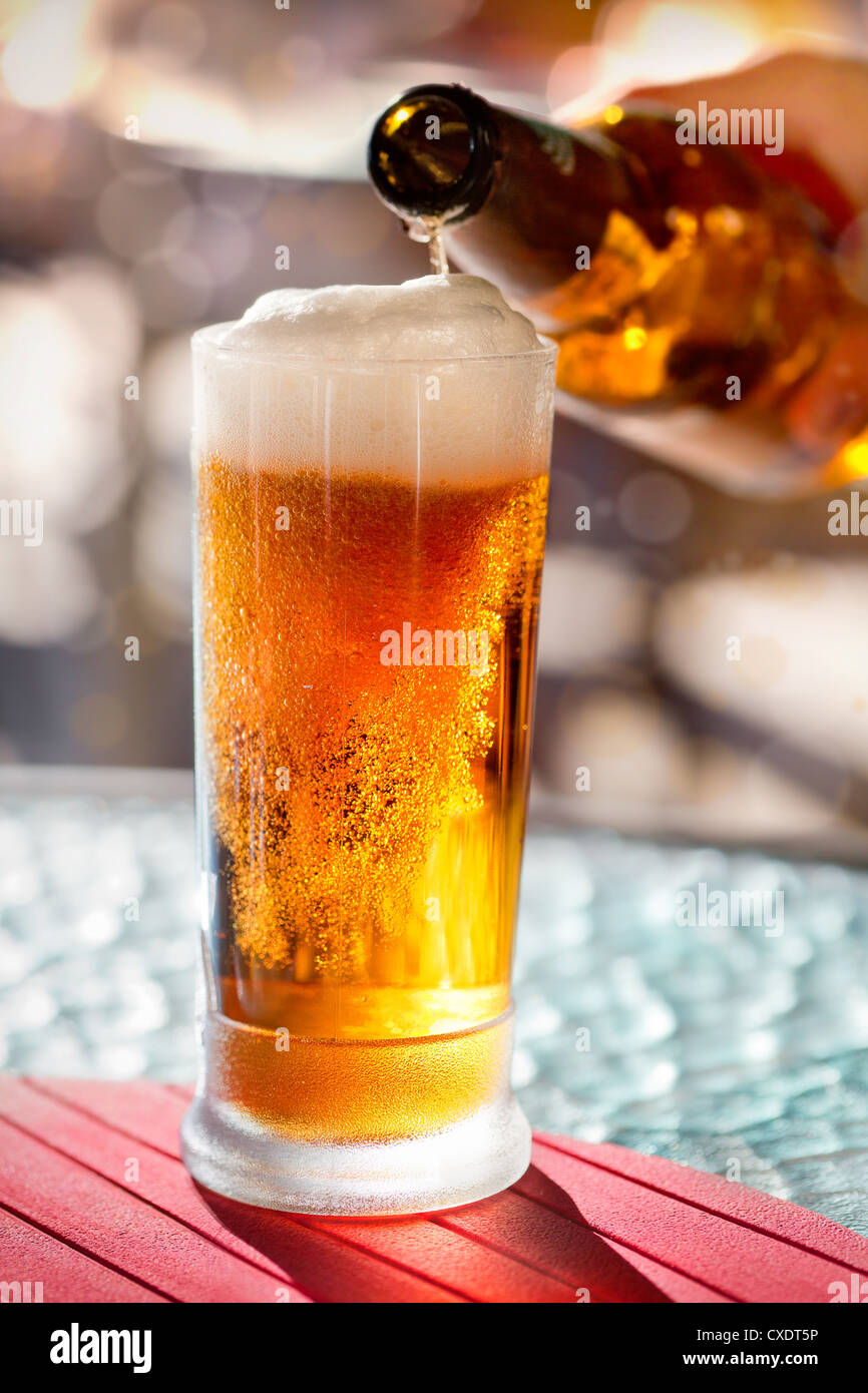 Pouring beer into mug from the bottle Stock Photo - Alamy