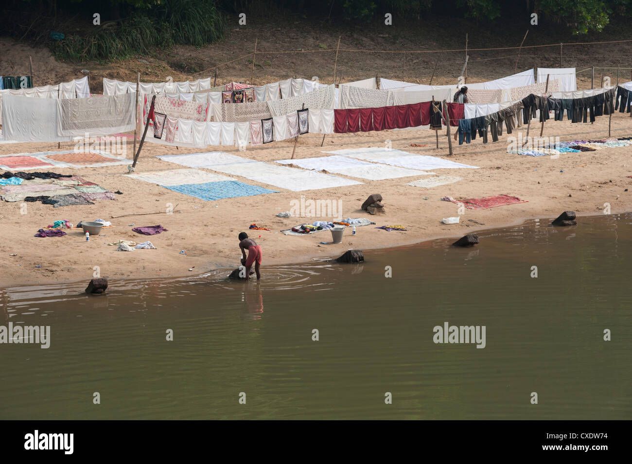 Dhobi wallah washing laundry in the river with neatly arranged Stock ...