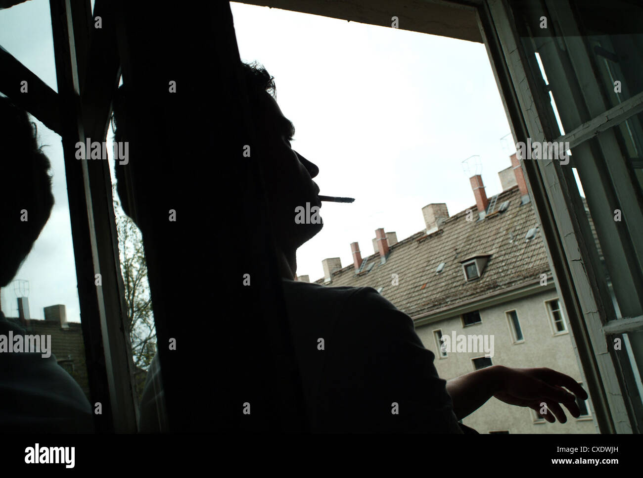 Berlin, smoking man at the window Stock Photo - Alamy