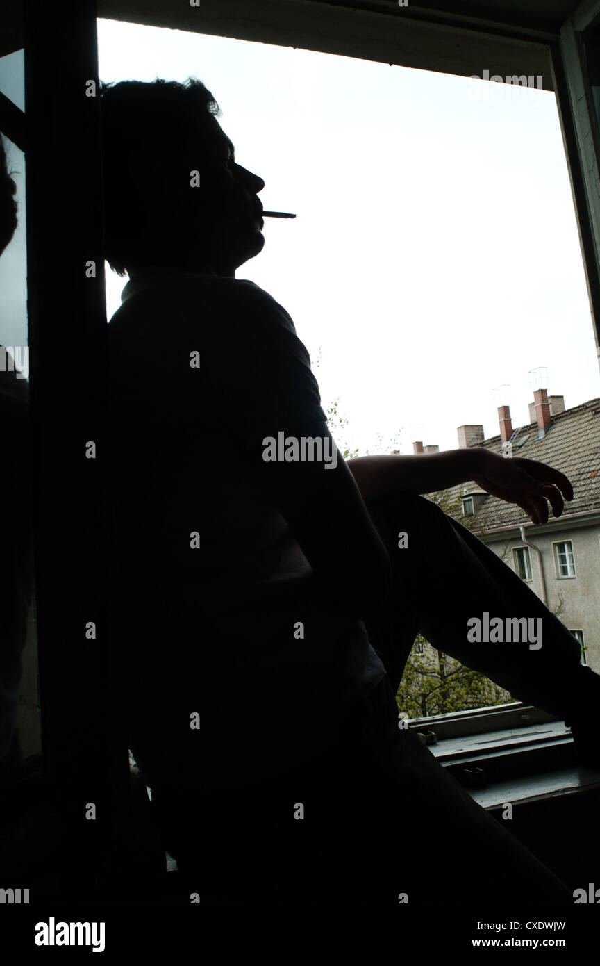 Berlin, smoking man at the window Stock Photo - Alamy