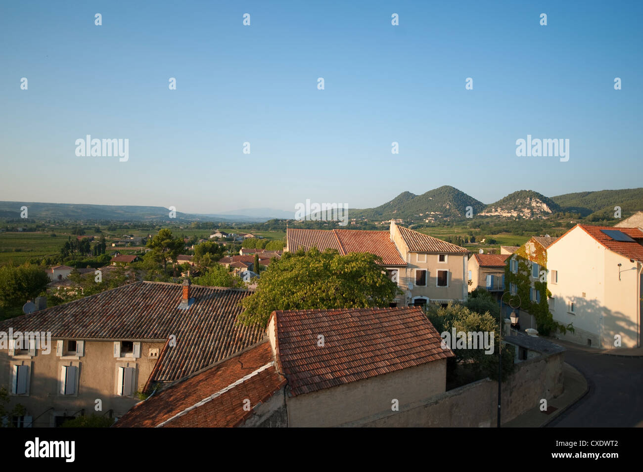 Rooftops of Sablet village at sunset looking towards Seguret village on ...