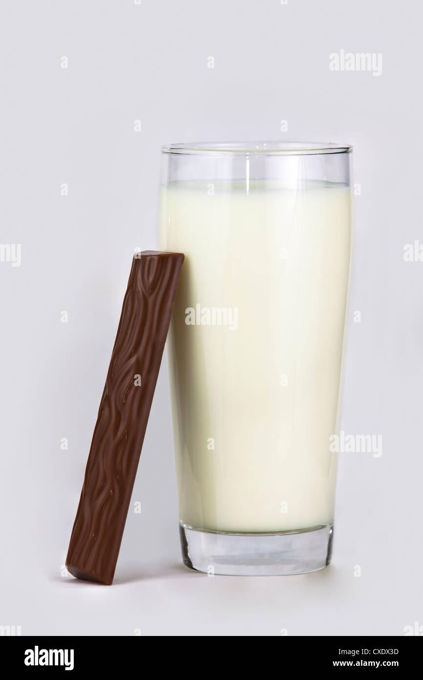 chocolate bar leaning at a glass of fresh milk Stock Photo - Alamy