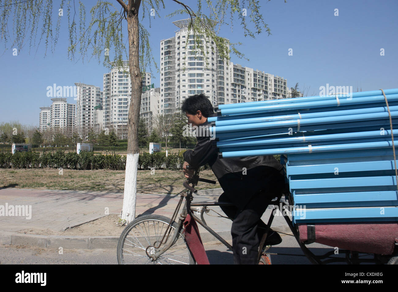 Beijing, fully loaded loads rickshaw and Wohnhochhaeuser Stock Photo ...