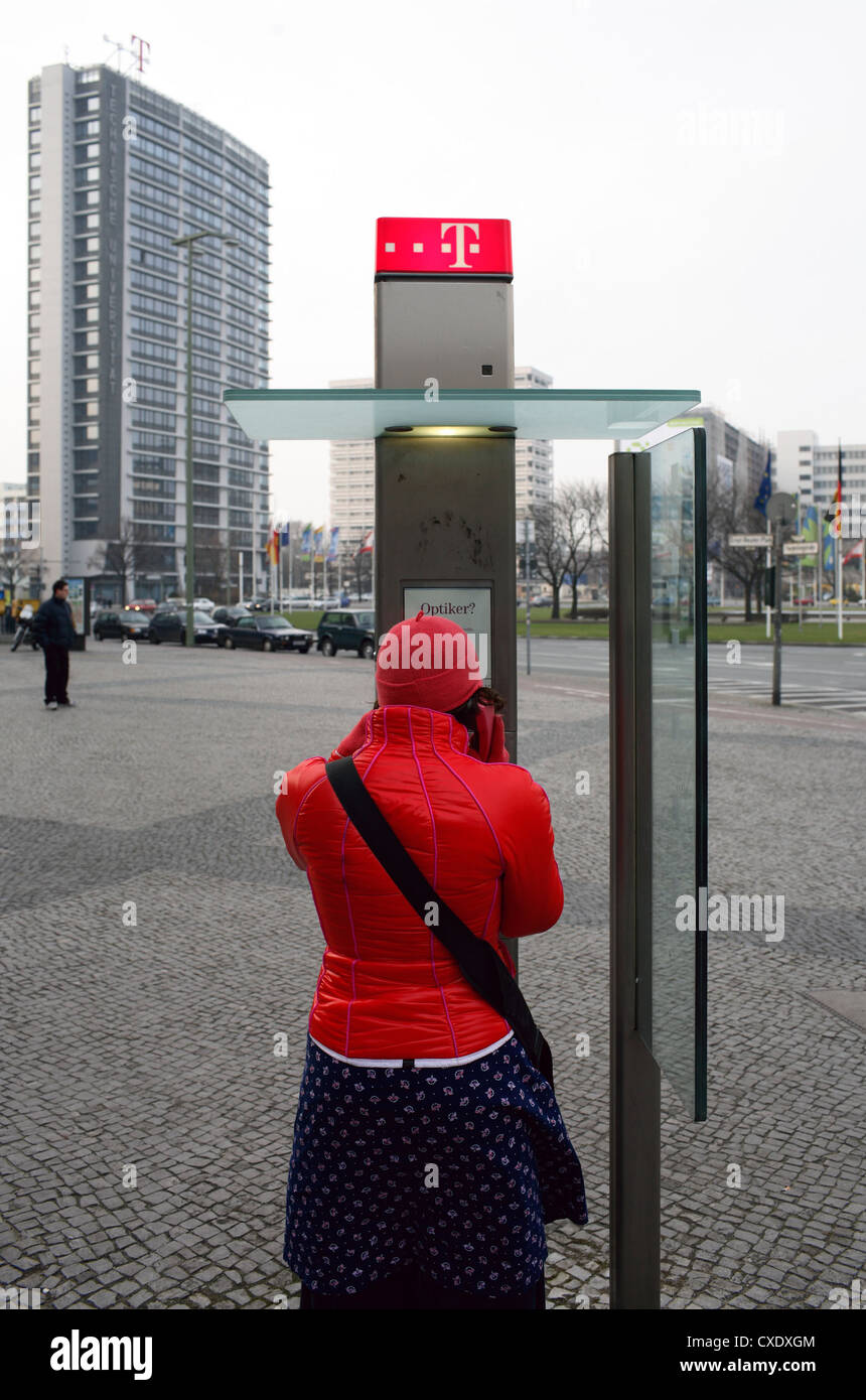 Berlin, a woman at a public phone booth Stock Photo - Alamy