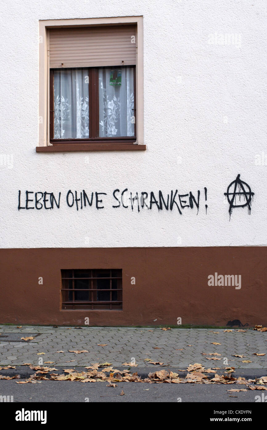 Saarbruecken, anarchist graffiti slogan on a freshly painted house wall ...