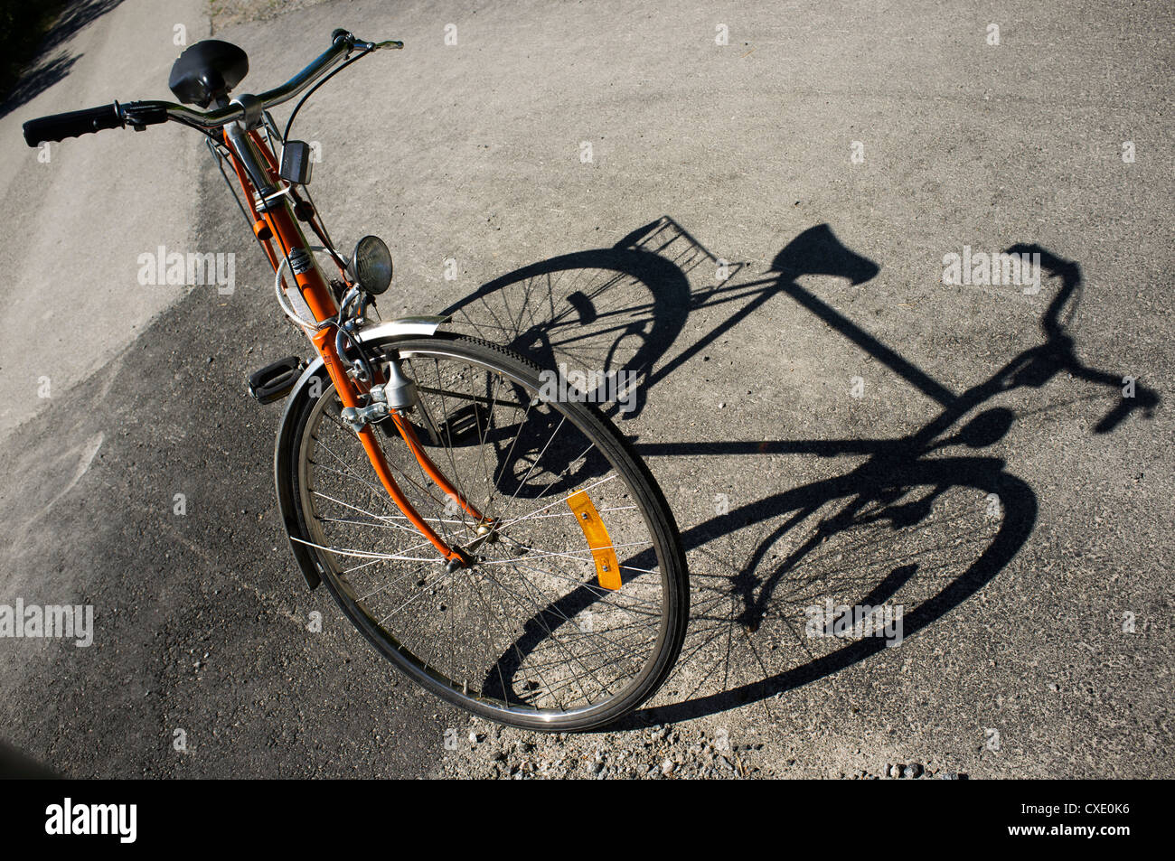 Bicycle casting shadow Stock Photo - Alamy