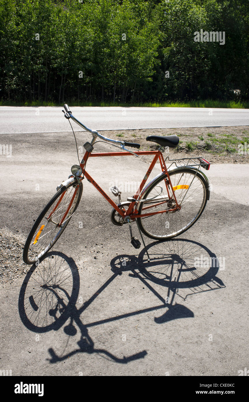 Bicycle casting shadow Stock Photo - Alamy