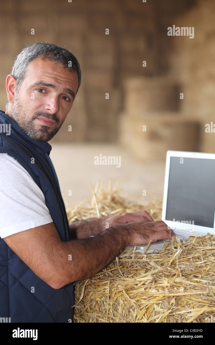 Farmer working at a laptop computer Stock Photo - Alamy