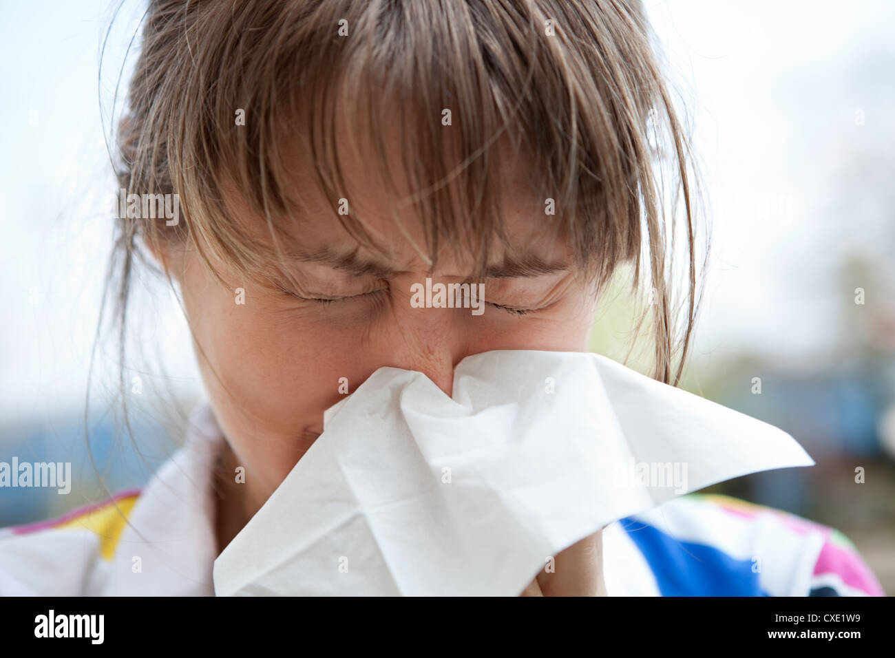 blonde female blowing her nose Stock Photo - Alamy