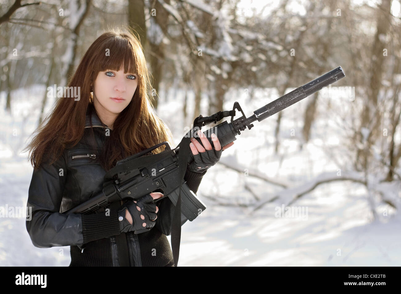Beautiful armed girl in the forest Stock Photo - Alamy