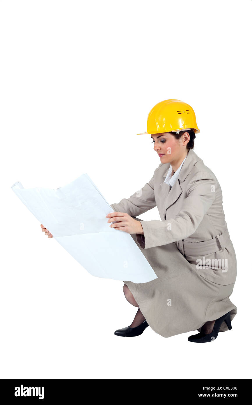 Female entrepreneur crouching on white background Stock Photo - Alamy