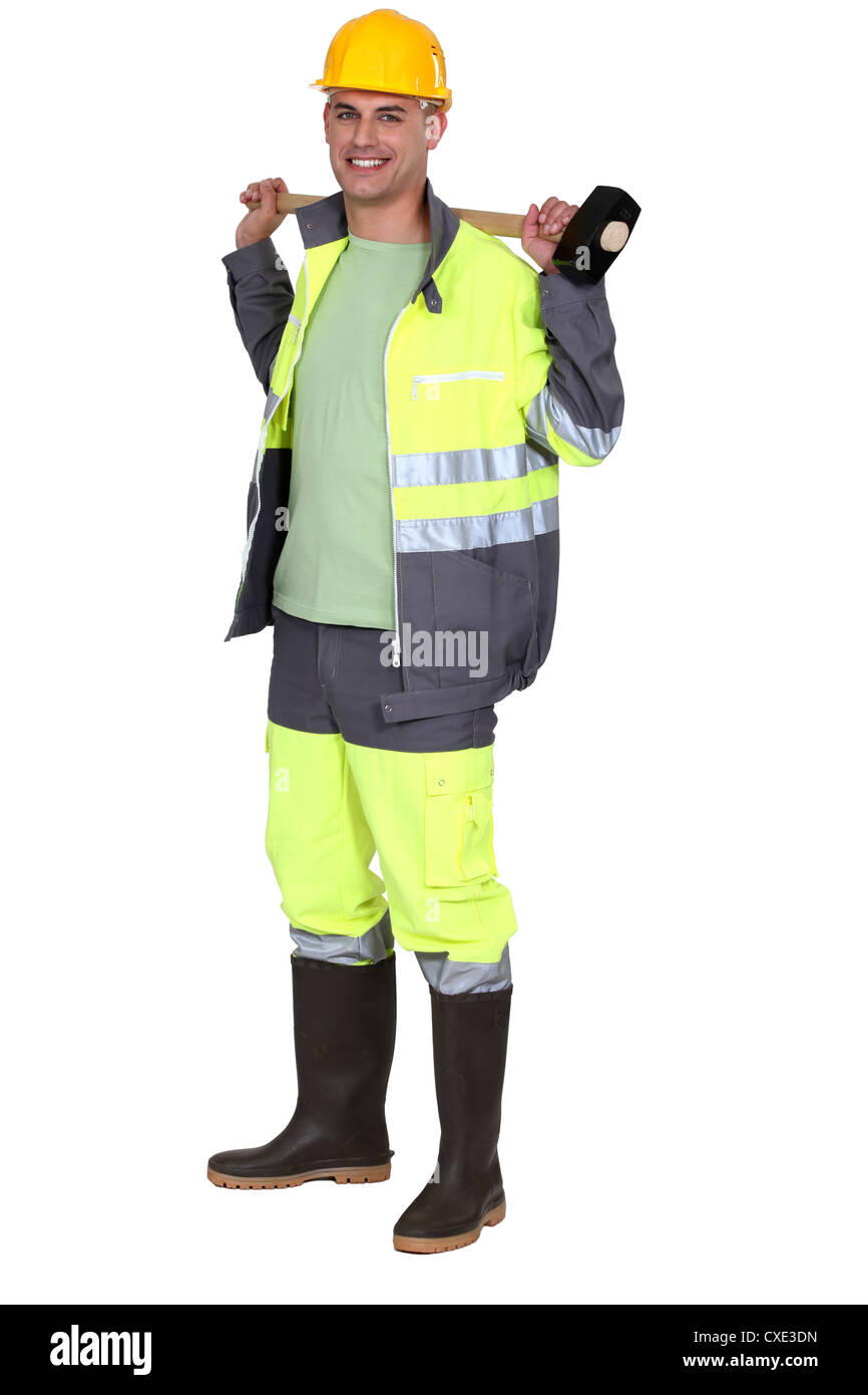 Man holding sledge hammer over shoulder Stock Photo - Alamy