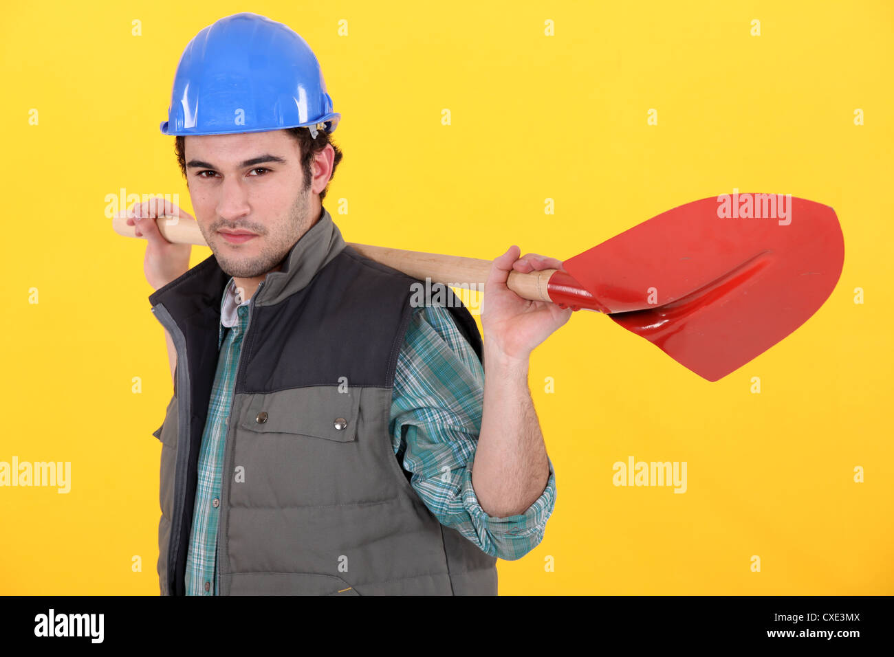 Worker with shovel Stock Photo - Alamy
