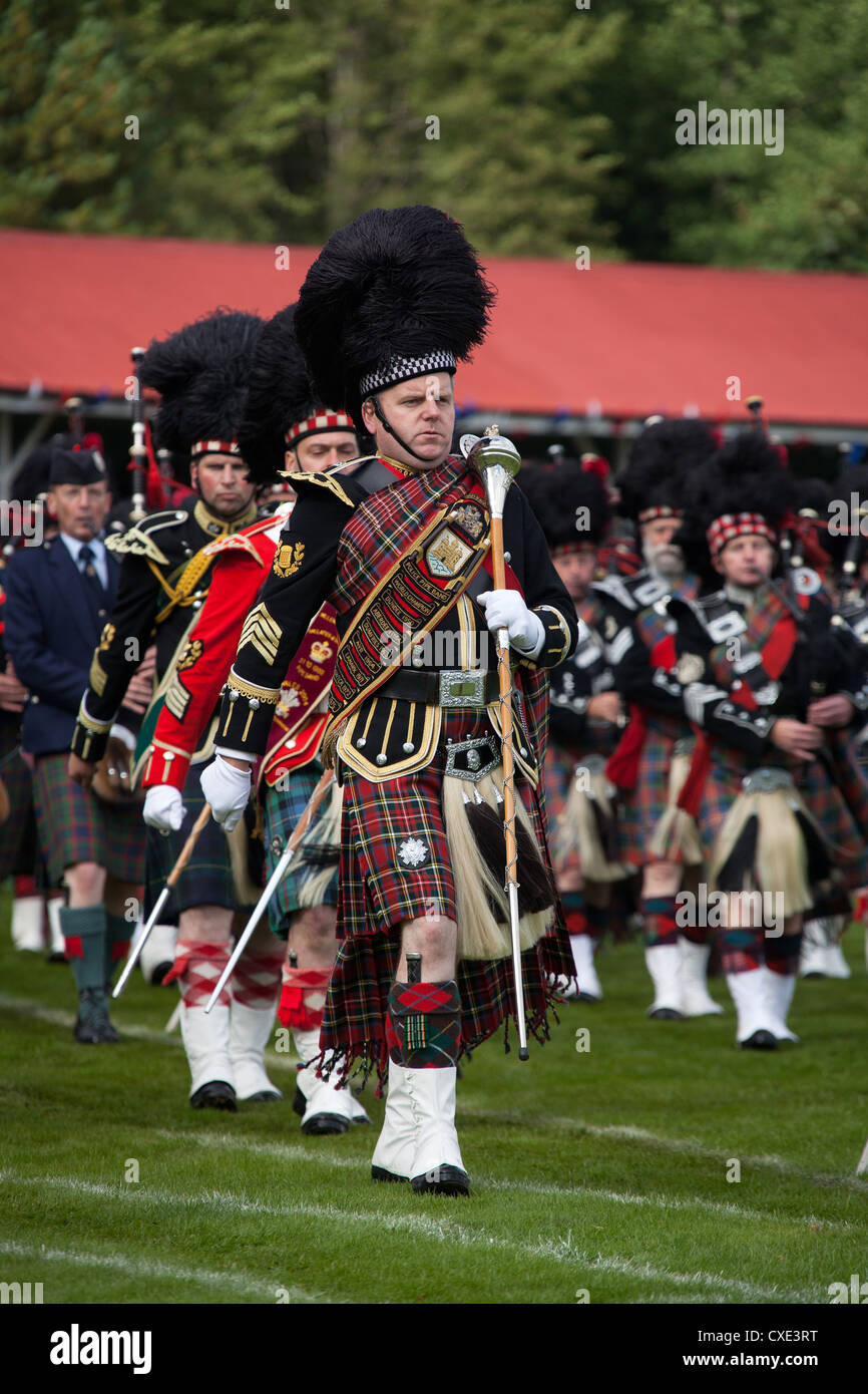 Village of Braemar, Scotland. A Drum Major marching with the massed ...