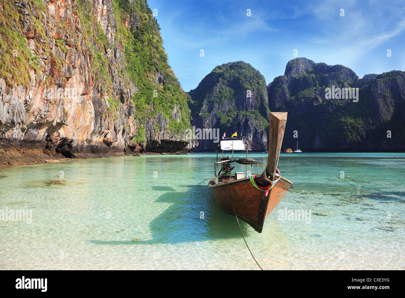 The Longtail boat in the clear water bay Stock Photo - Alamy