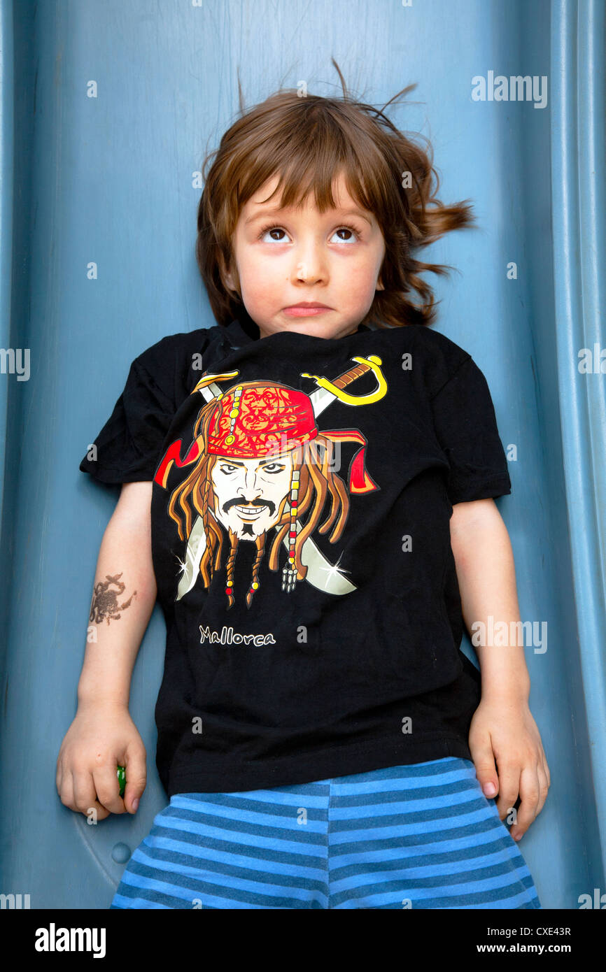 Young boy coming down a slide Stock Photo - Alamy