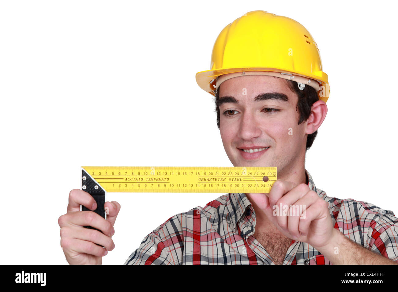 Young tradesman holding a try square Stock Photo - Alamy