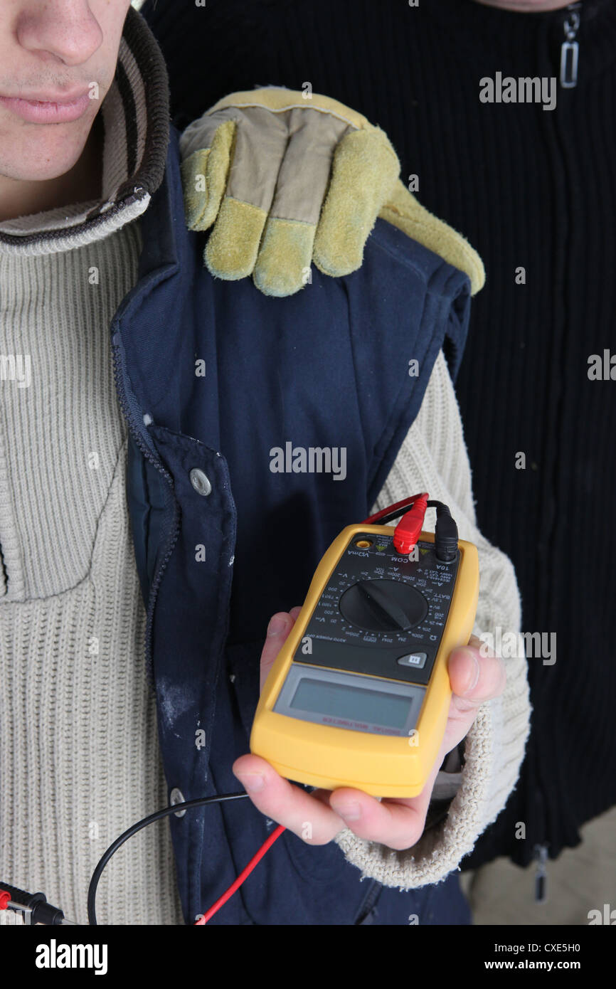 Electrician with an ampmeter Stock Photo - Alamy