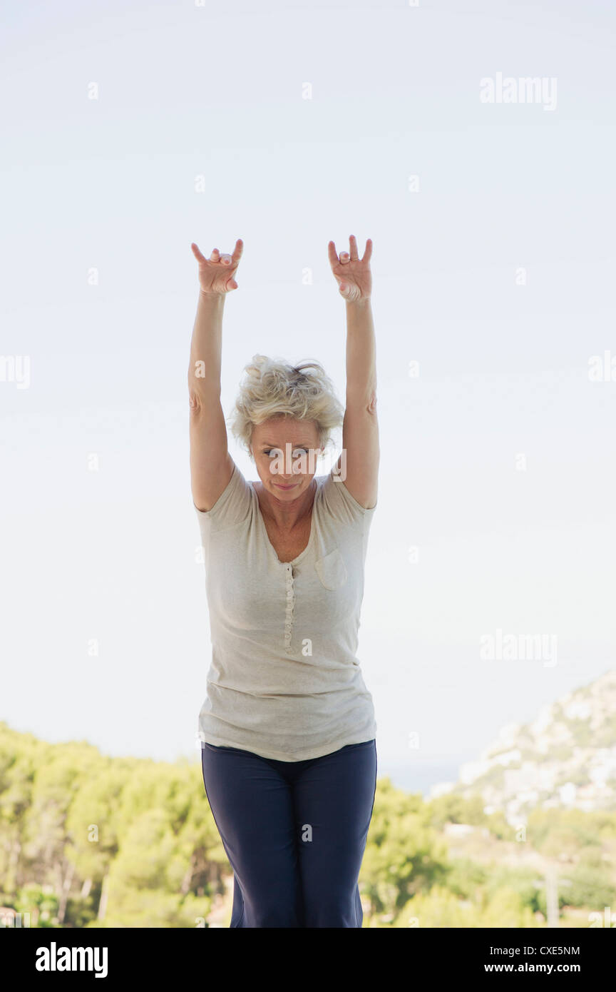 Mature woman doing sun salutation pose Stock Photo - Alamy