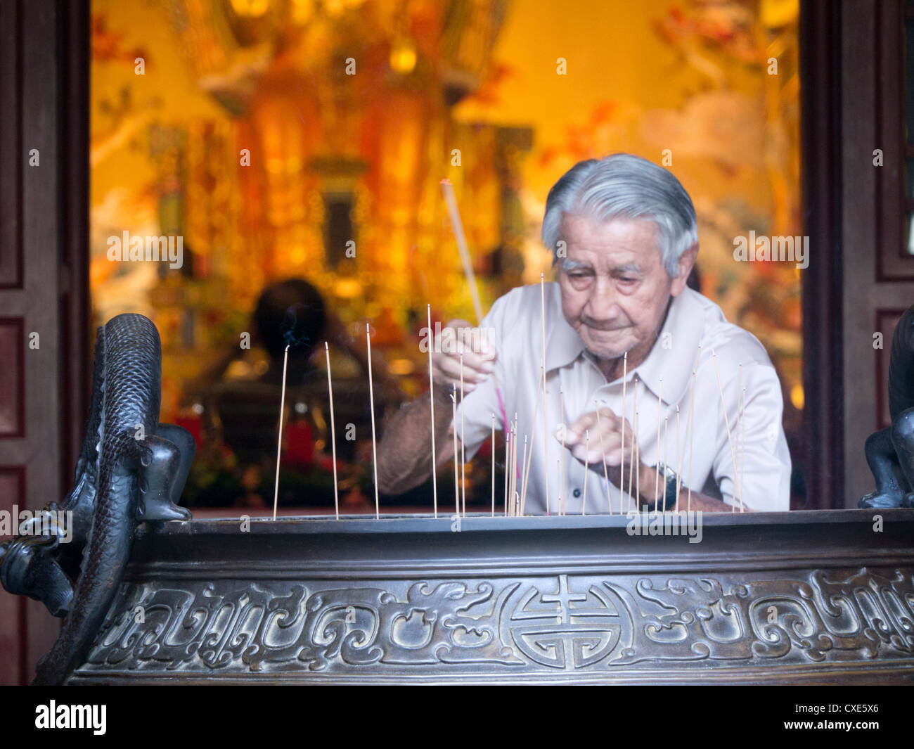 Chinese Lady lighting Incense Sticks, Chinese Temple, Singapore Stock ...