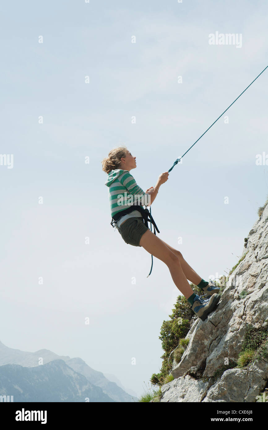Preteen girl rock climbing Stock Photo - Alamy