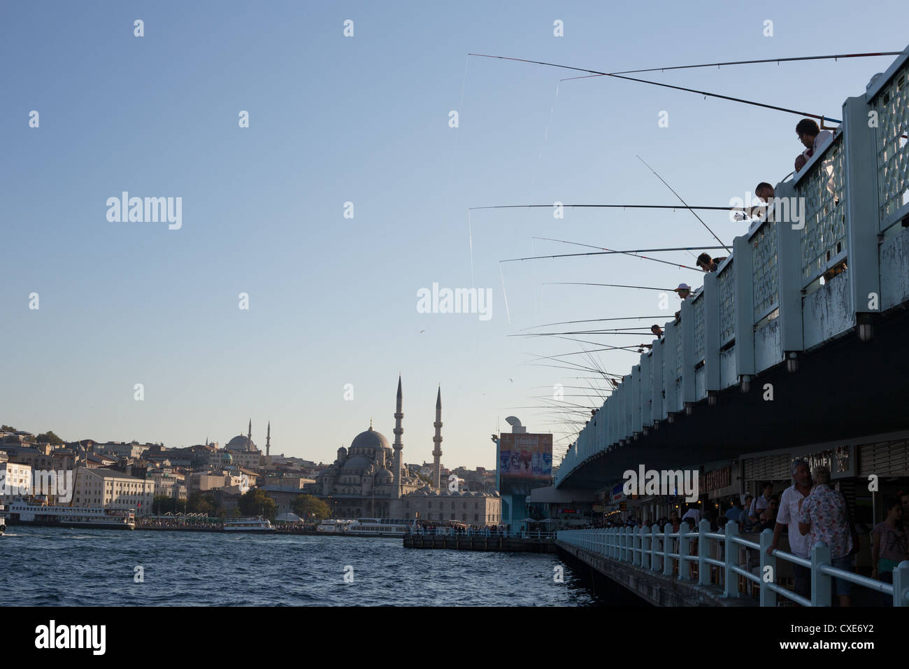 Galata Bridge, full with men fishing, across the Bosphorus, in Istanbul ...