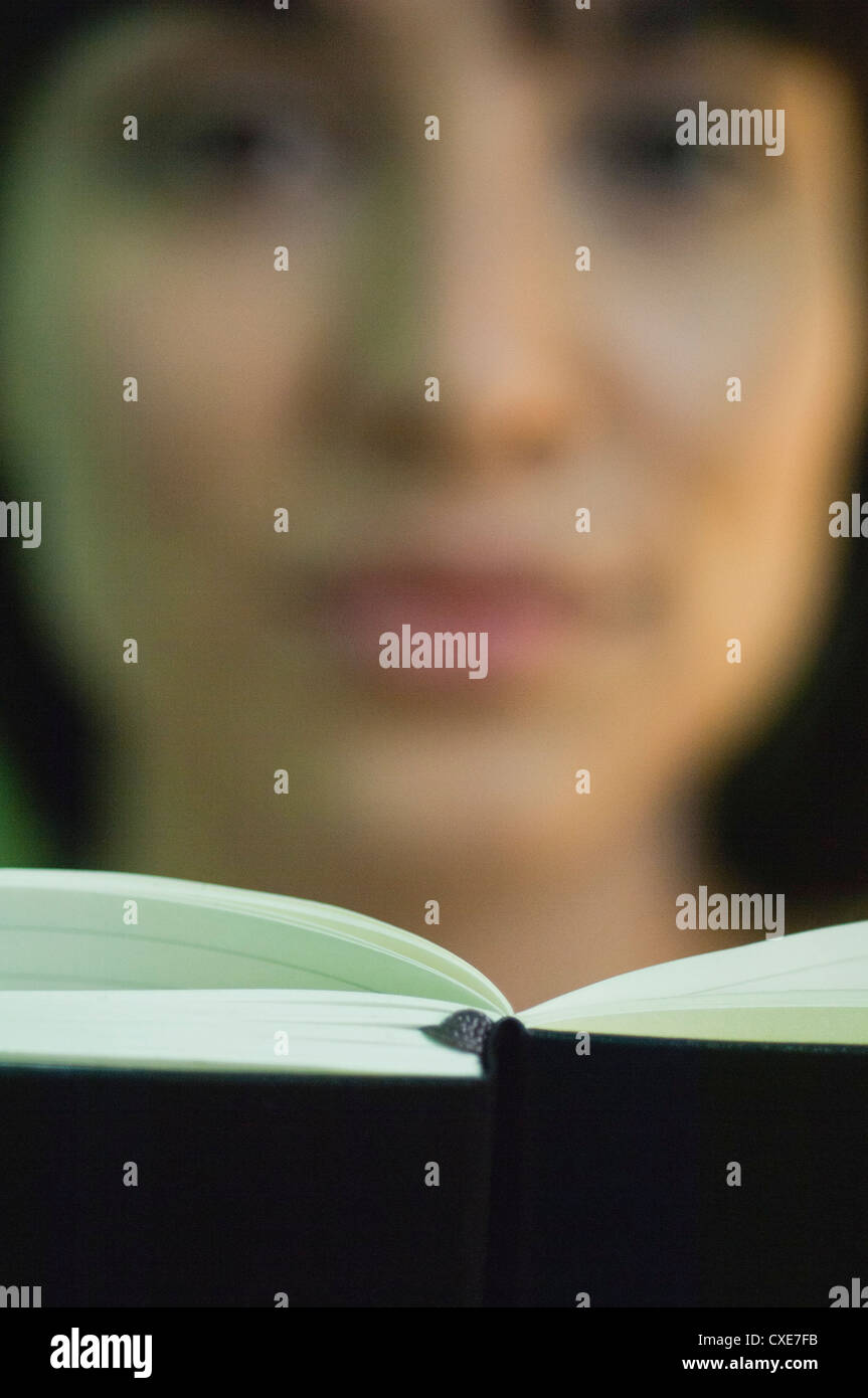 Woman reading, focus on book Stock Photo - Alamy