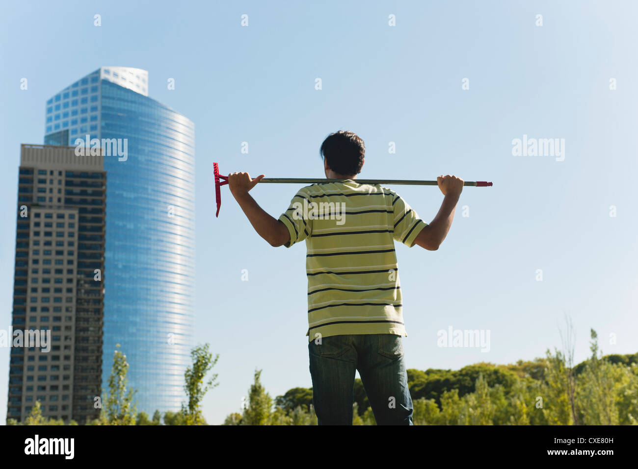Farmer standing in field, contemplating skyscrapers Stock Photo - Alamy
