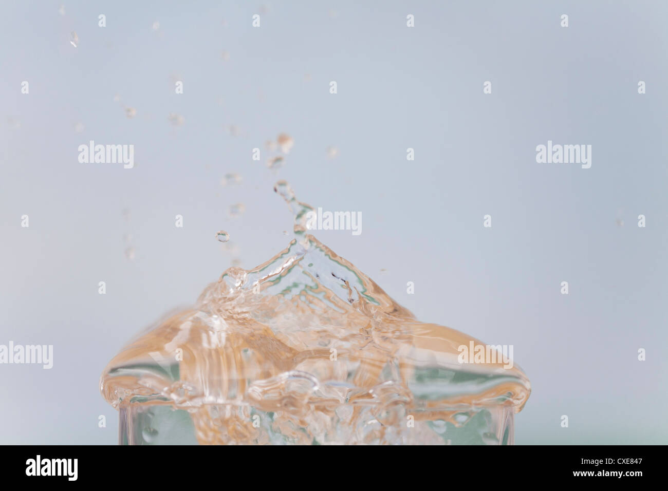 Water splashing out of glass Stock Photo - Alamy