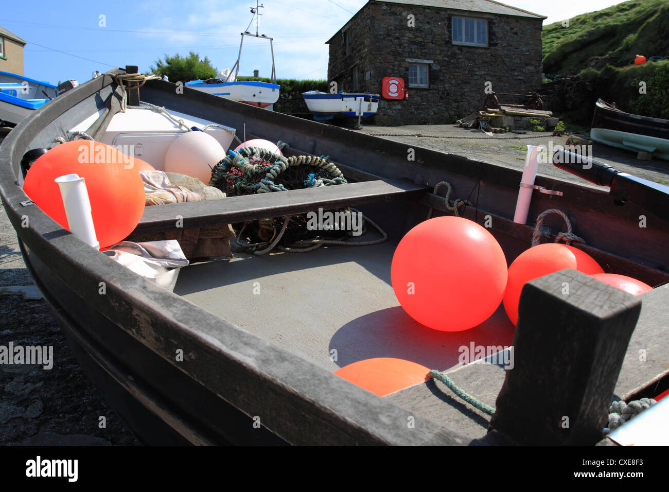Small Fishing Boat With Orange Net Floats Stock Photo - Alamy