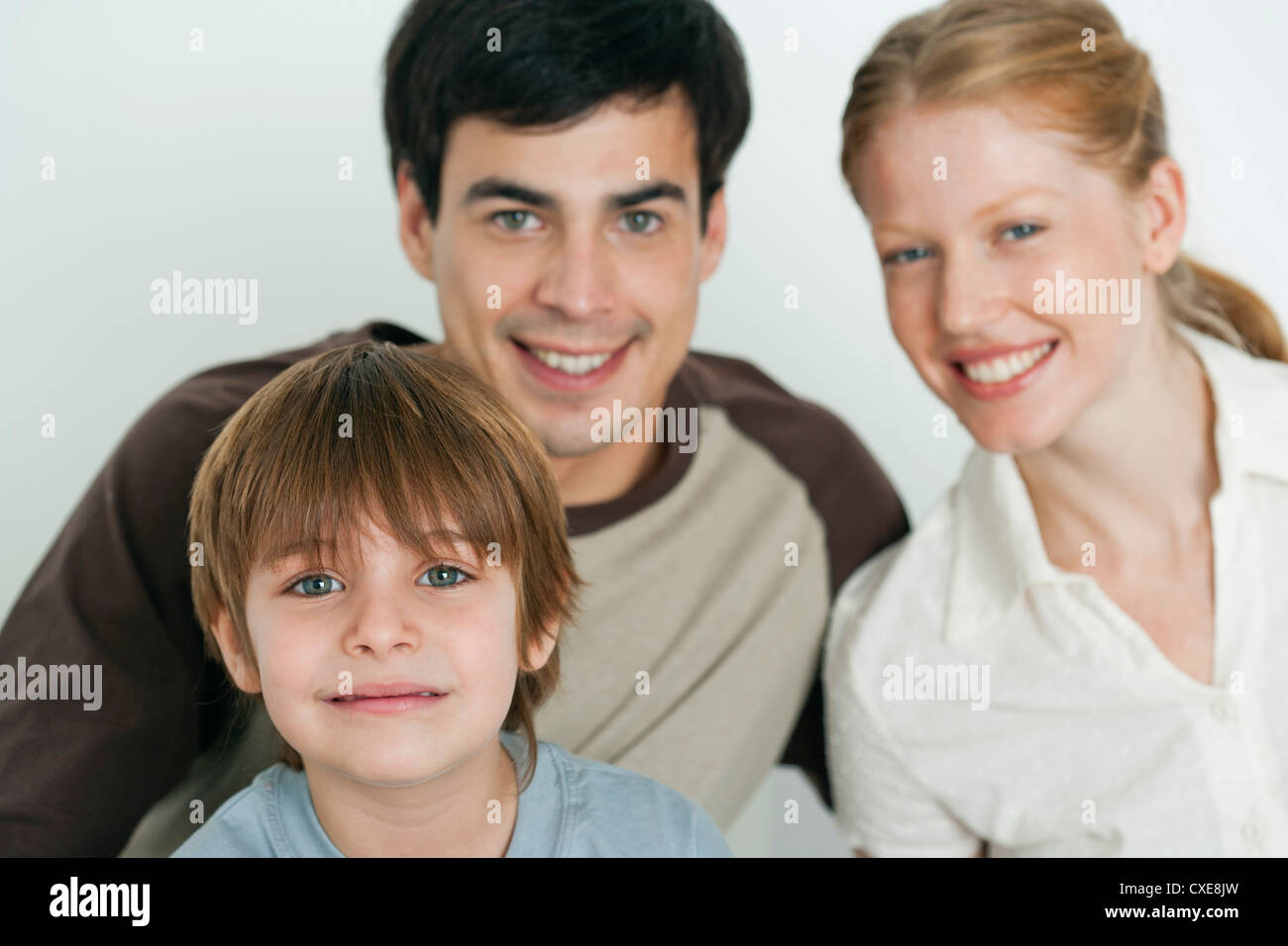Boy with parents, focus on foreground Stock Photo - Alamy