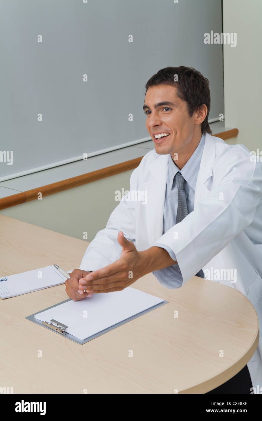 Doctor greeting patient in office Stock Photo - Alamy